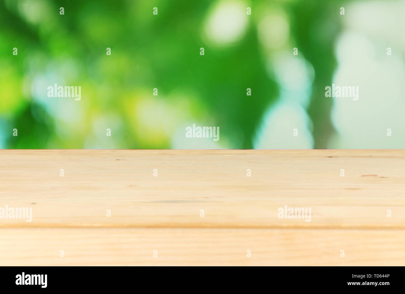 Wooden table on bright background Stock Photo - Alamy