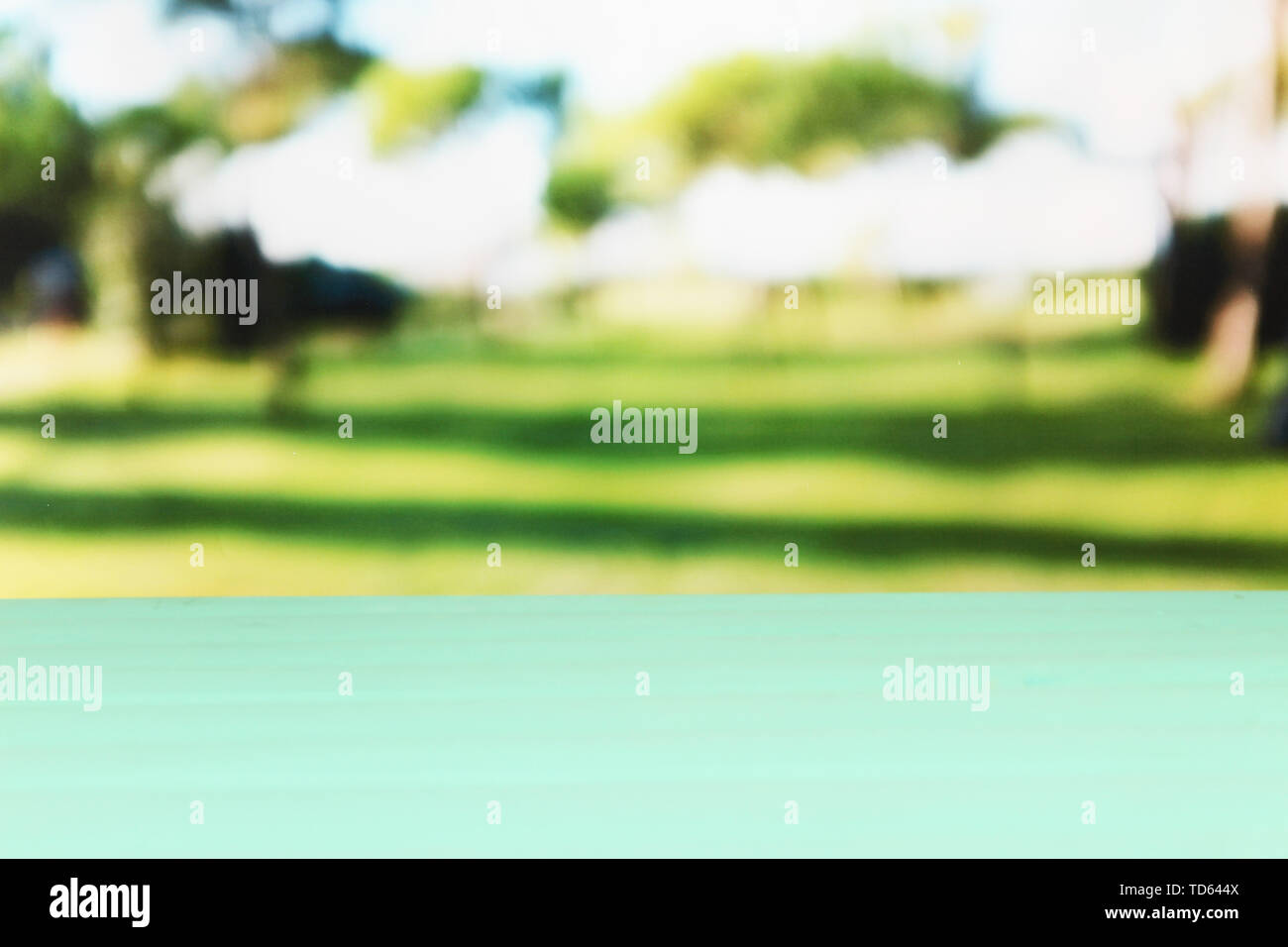 Wooden table on park background Stock Photo - Alamy