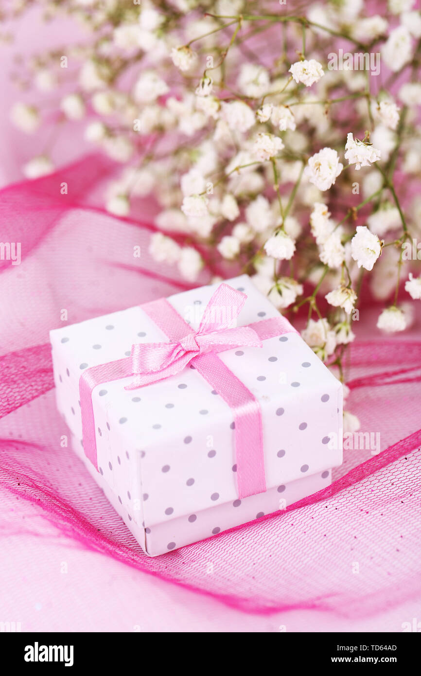 Flowers and gift box on pink background Stock Photo - Alamy