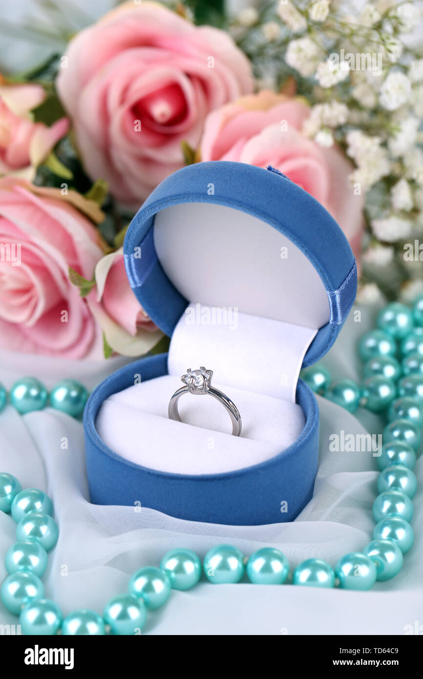 Roses and a ring on a white cloth Stock Photo - Alamy