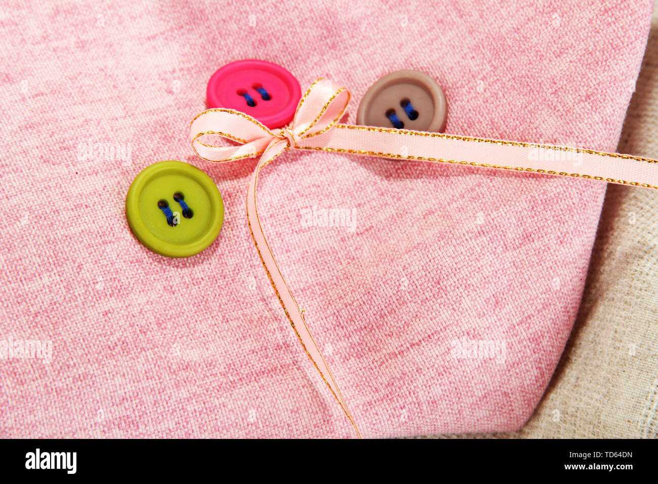 Three buttons on light cloth Stock Photo - Alamy