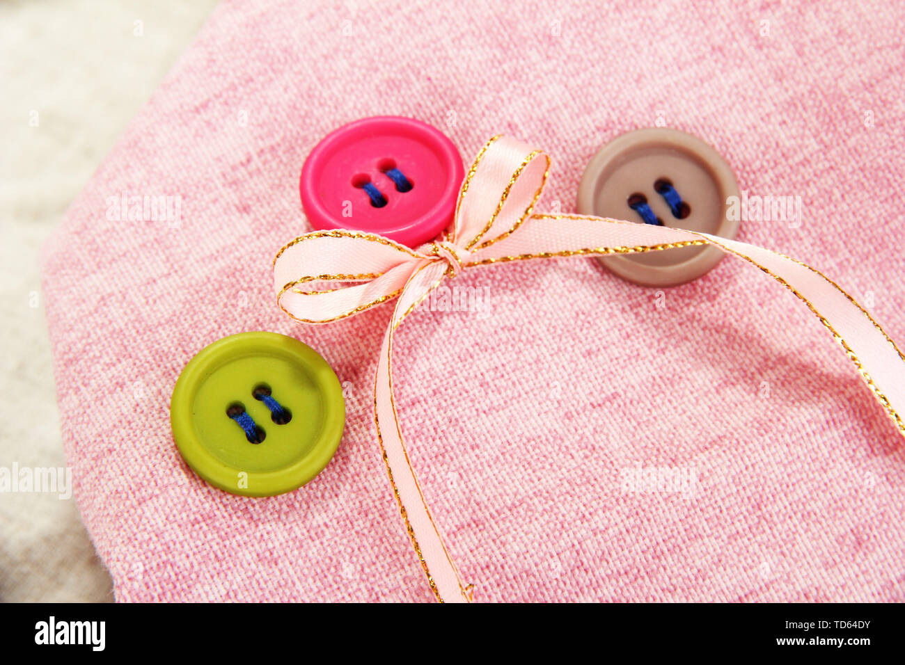 Three buttons on light cloth Stock Photo - Alamy