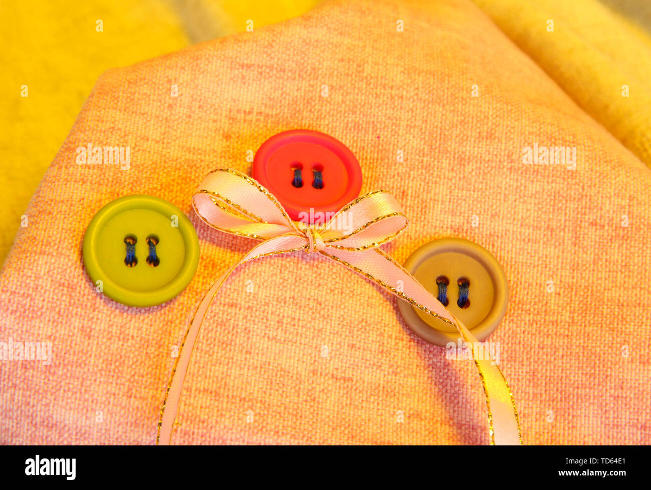 Three buttons on light cloth Stock Photo - Alamy