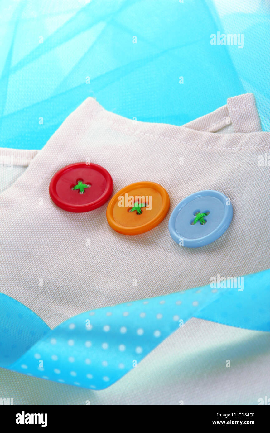 Three buttons on beige and blue cloth Stock Photo - Alamy