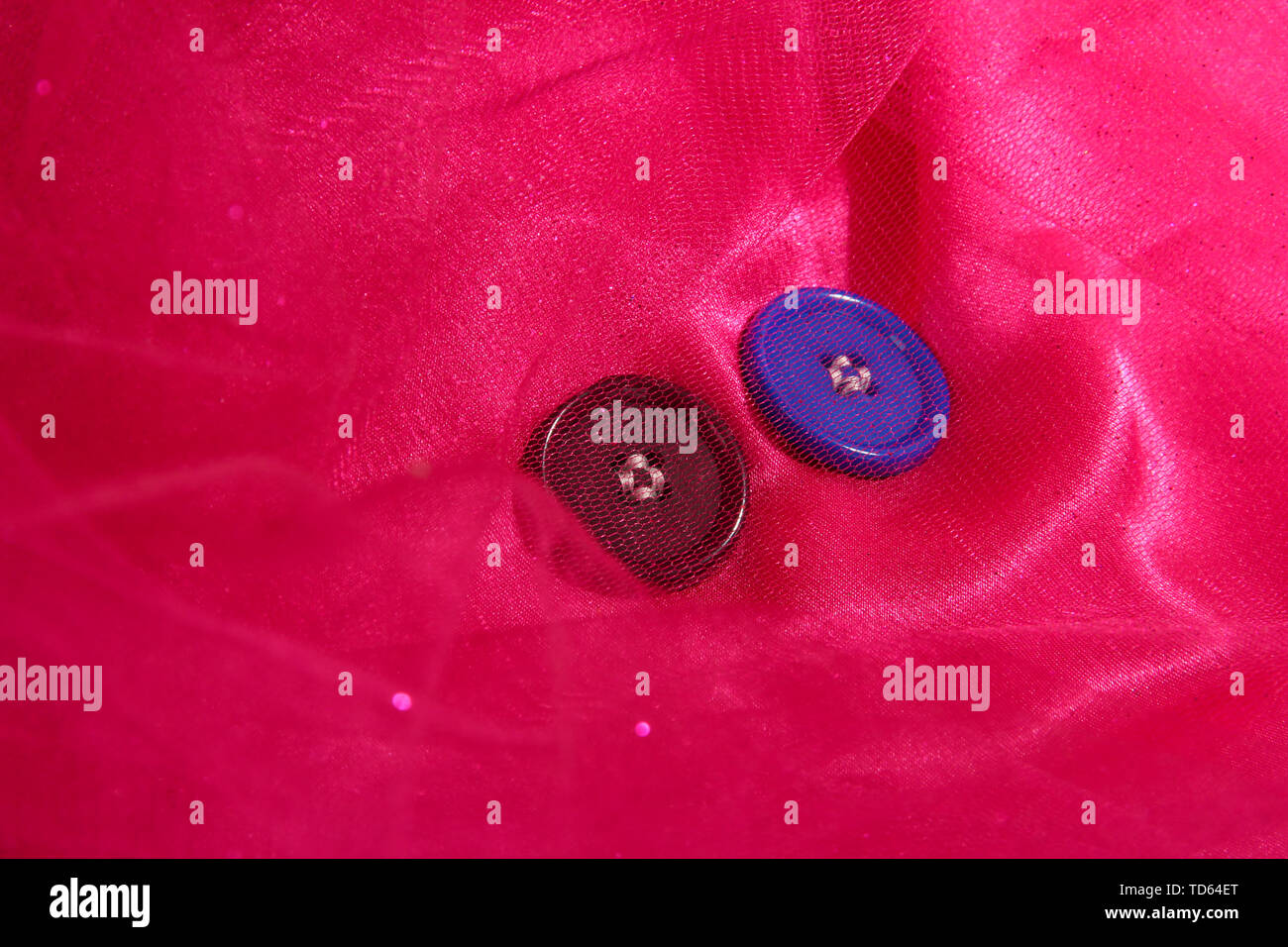 Two buttons on pink background Stock Photo - Alamy