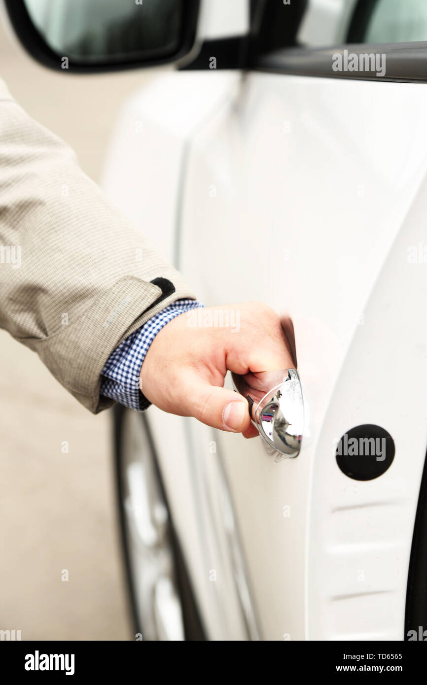 Man hand opening car door, close up Stock Photo - Alamy