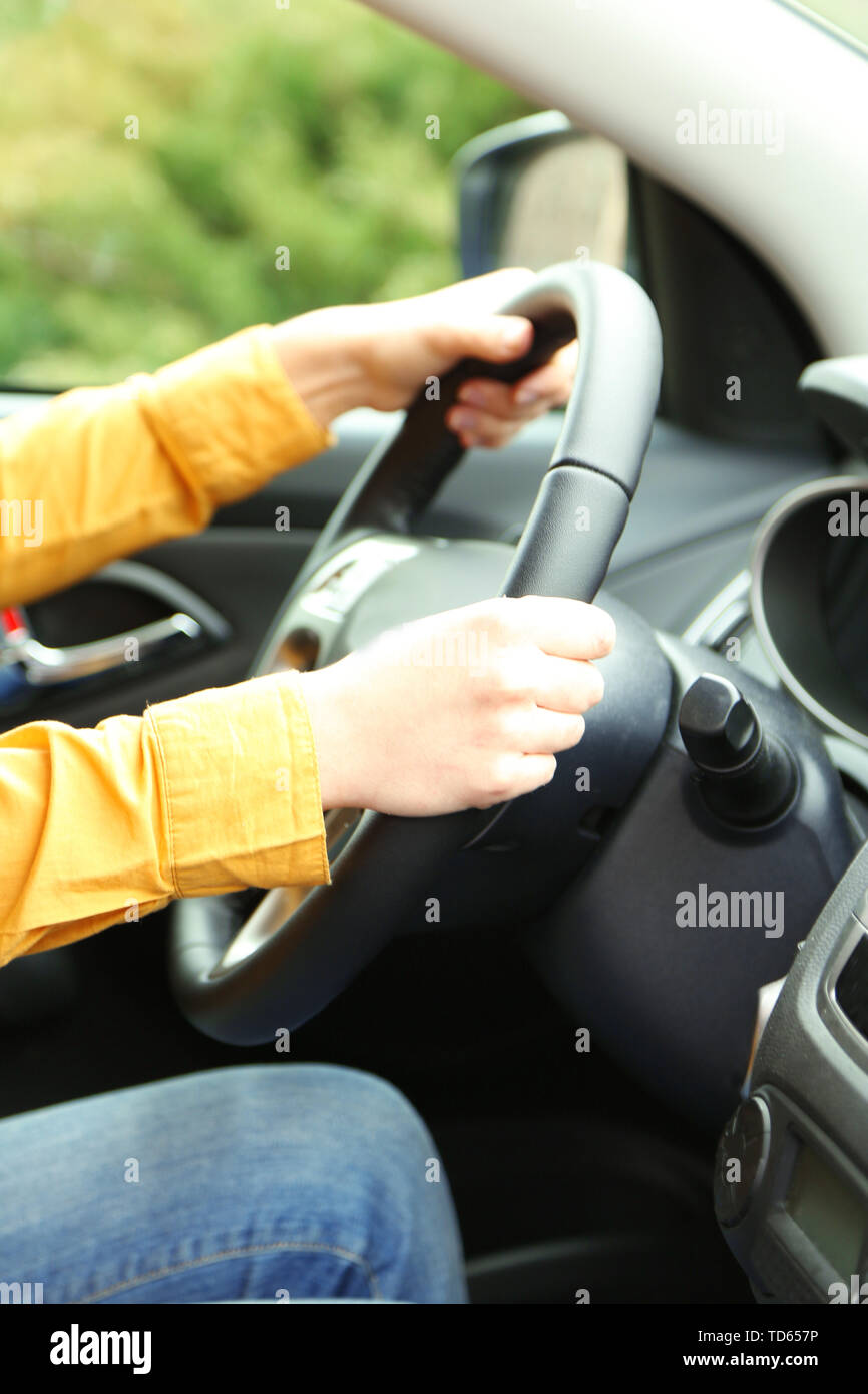 Female hands over a wheel in the car, close up Stock Photo - Alamy
