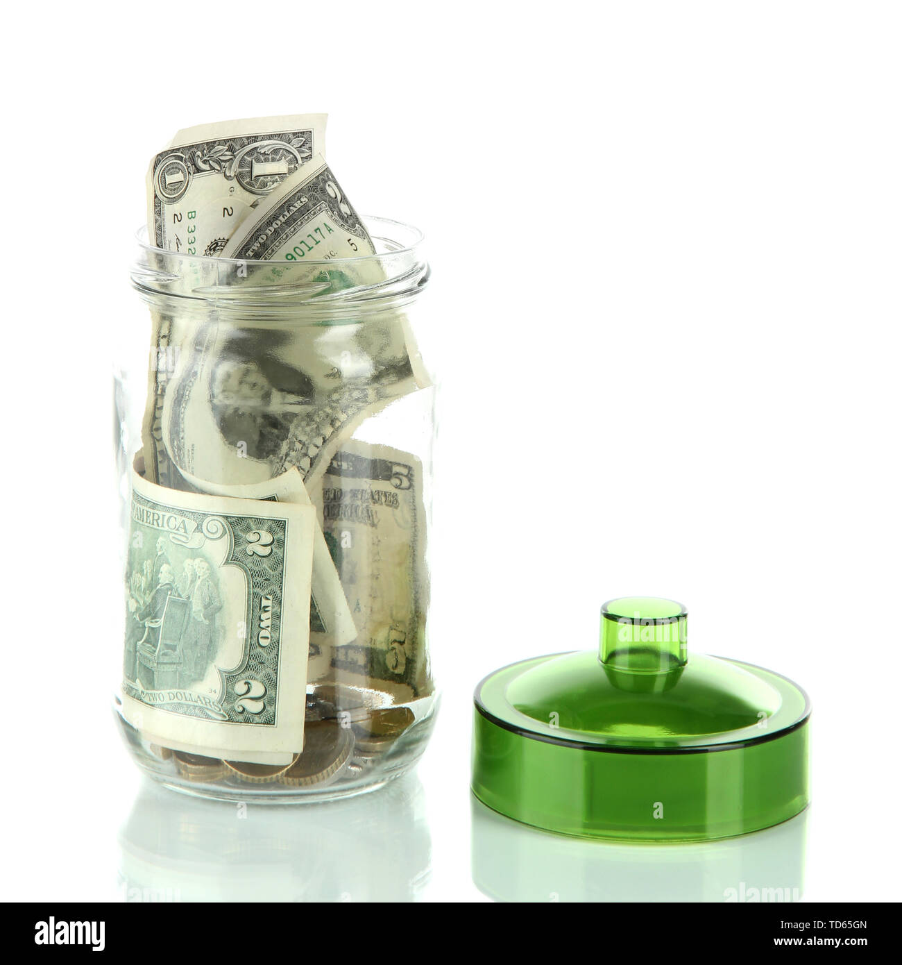 Glass jar with money isolated on white Stock Photo - Alamy
