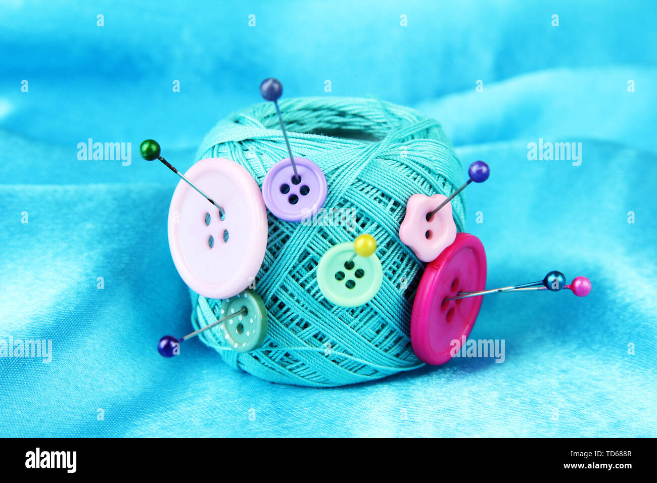 Colorful buttons and wool ball, on color fabric background Stock Photo ...