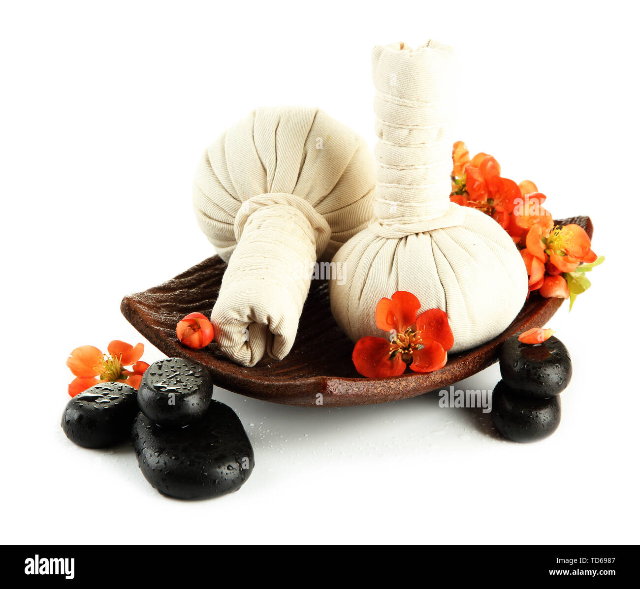 Herbal compress balls for spa treatment and spa stones isolated on ...