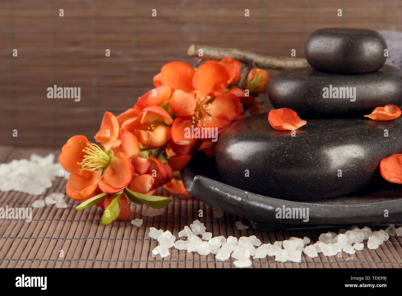 Spa stones and flowers on bamboo background Stock Photo - Alamy