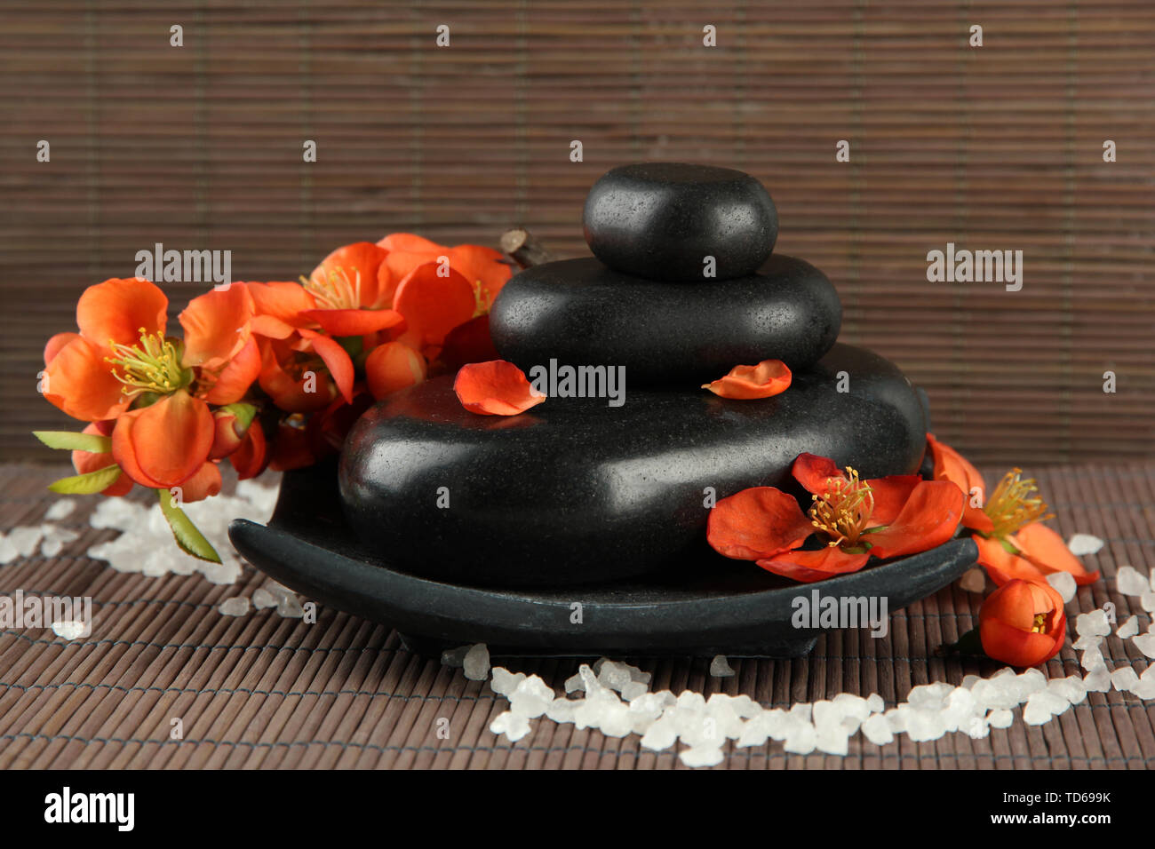 Spa stones and flowers on bamboo background Stock Photo - Alamy