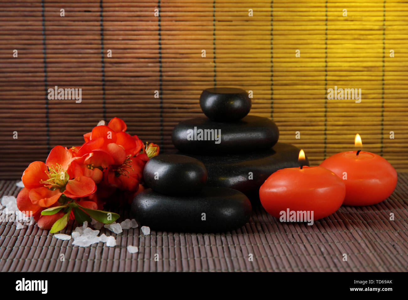 Spa stones with flowers and candles on bamboo background Stock Photo ...
