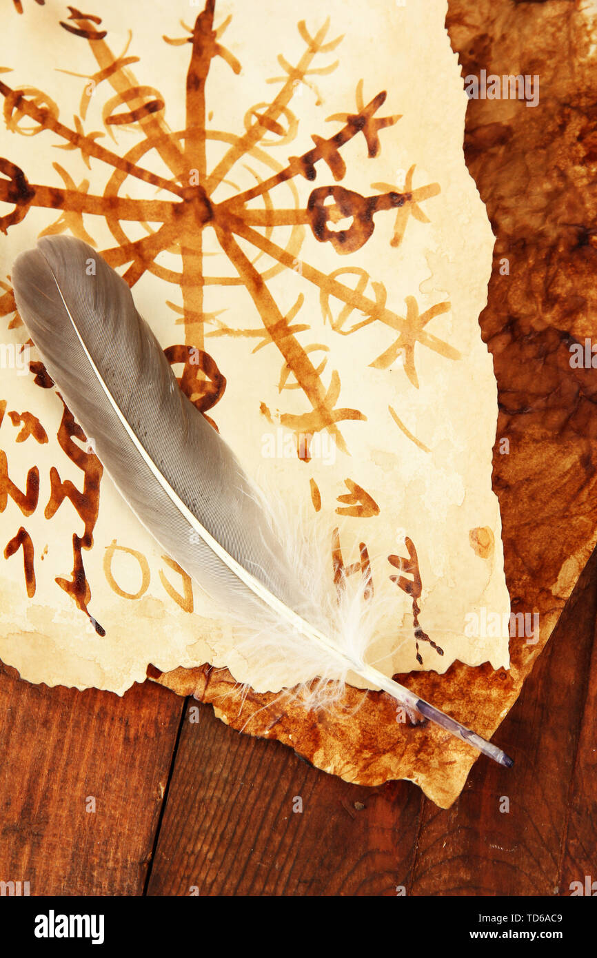 Old papers with symbols on wooden background Stock Photo - Alamy