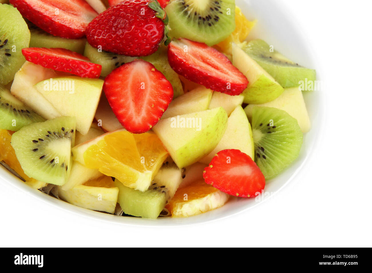 Useful fruit salad of fresh fruits and berries in bowl isolated on ...