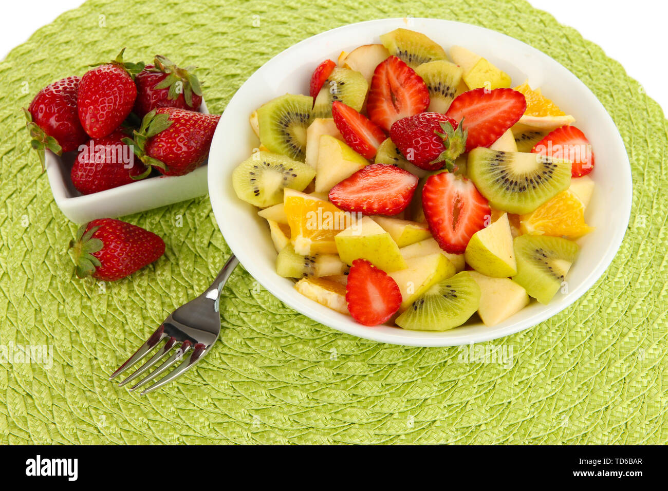 Useful fruit salad of fresh fruits and berries in bowl on napkin ...