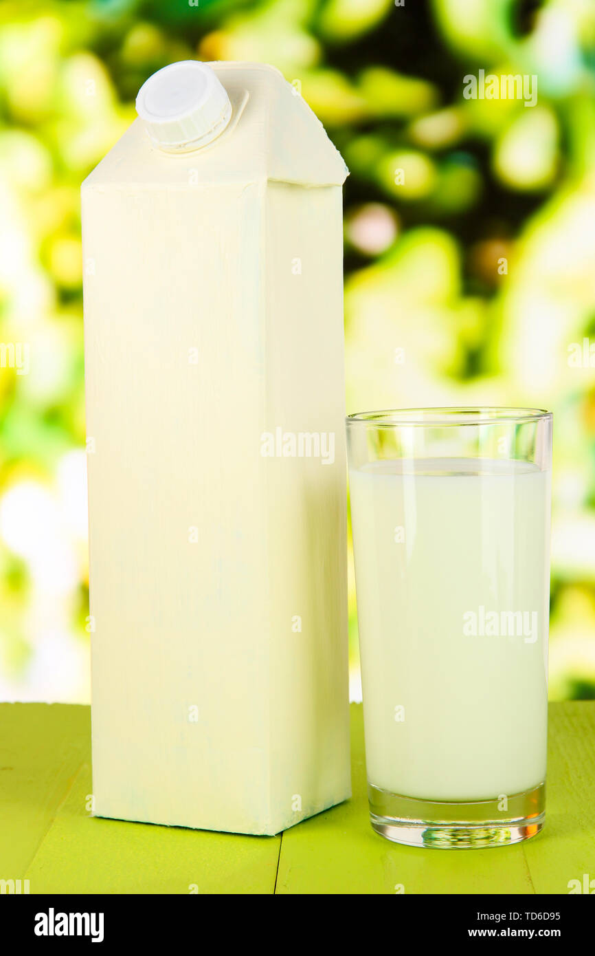 Milk pack on table on bright background Stock Photo - Alamy