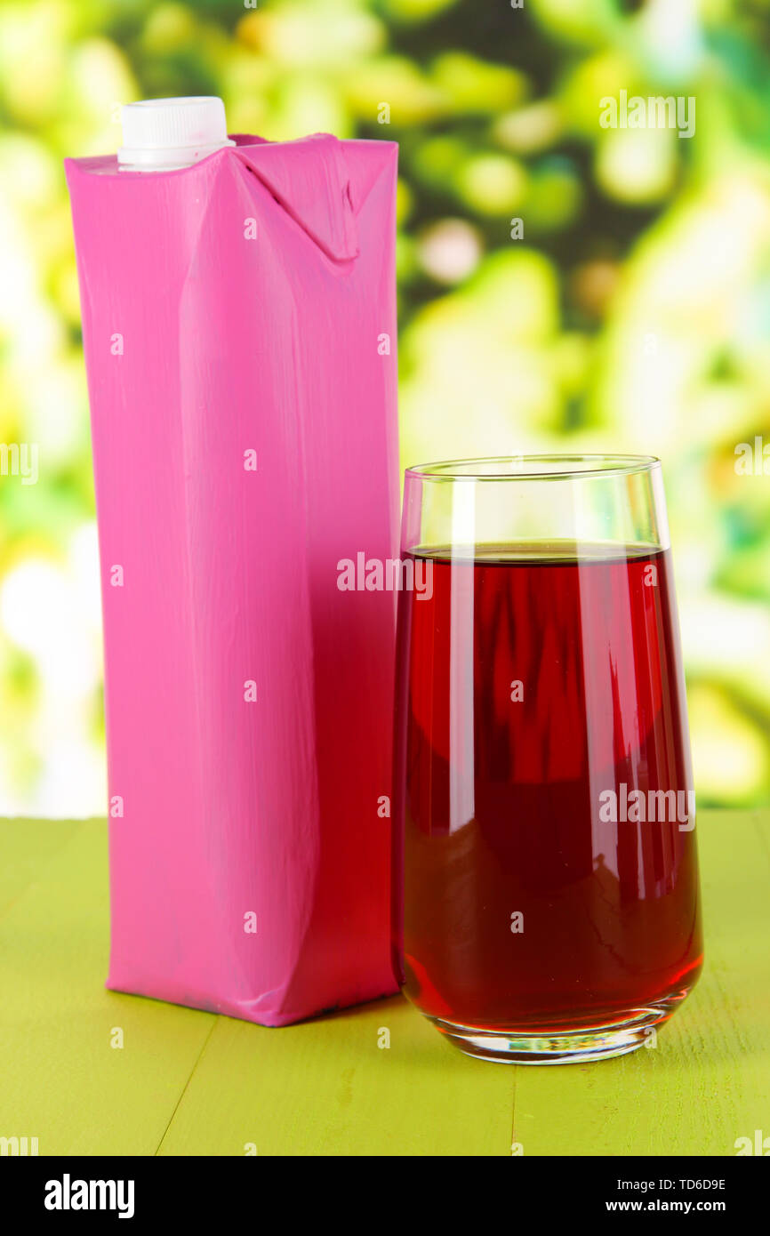 Juice pack on table on bright background Stock Photo - Alamy