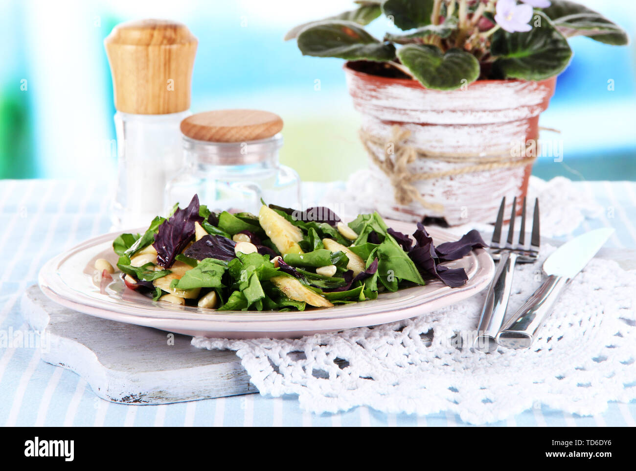 Light salad on plate on table on room background Stock Photo - Alamy