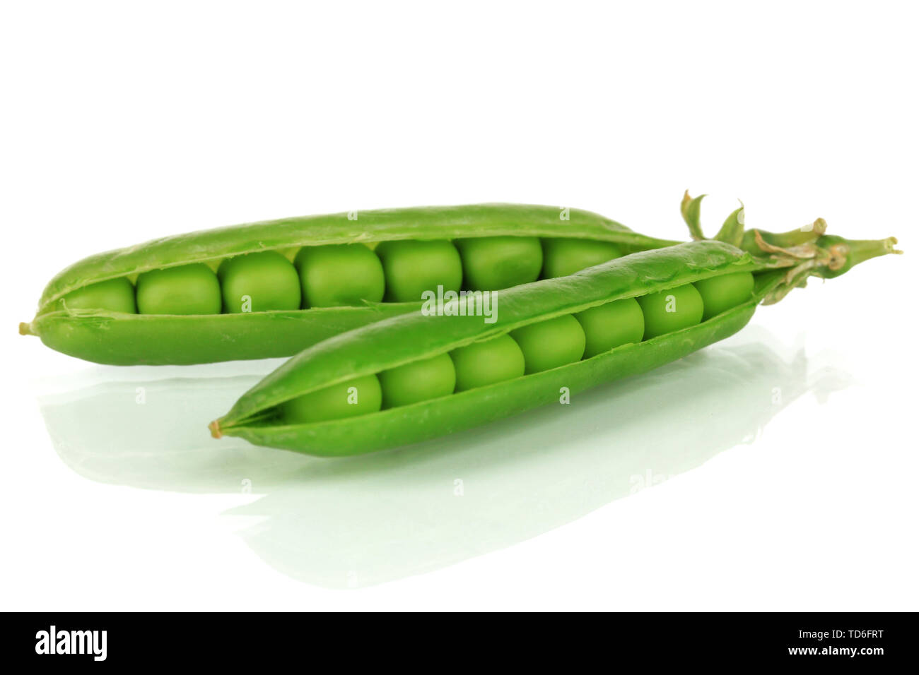 Sweet green peas isolated on white Stock Photo - Alamy