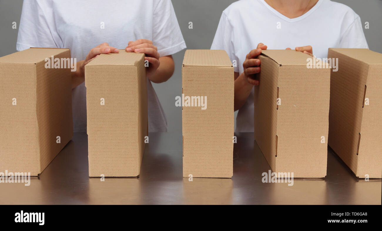 Workers working with boxes at conveyor belt, on grey background Stock ...