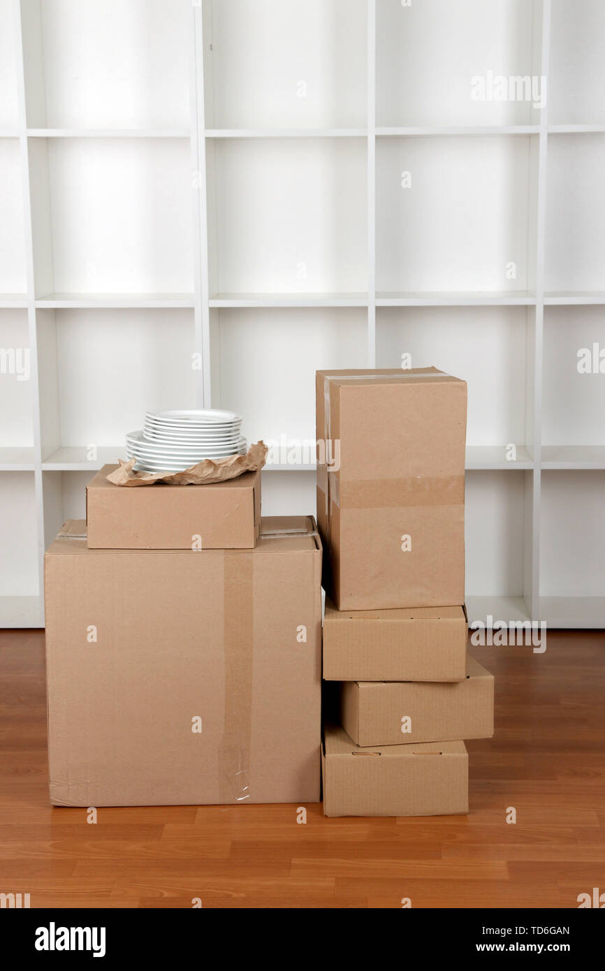 Moving boxes in empty room Stock Photo - Alamy