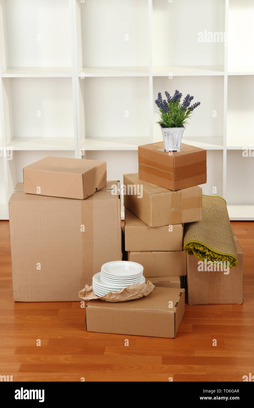 Moving boxes in empty room Stock Photo - Alamy