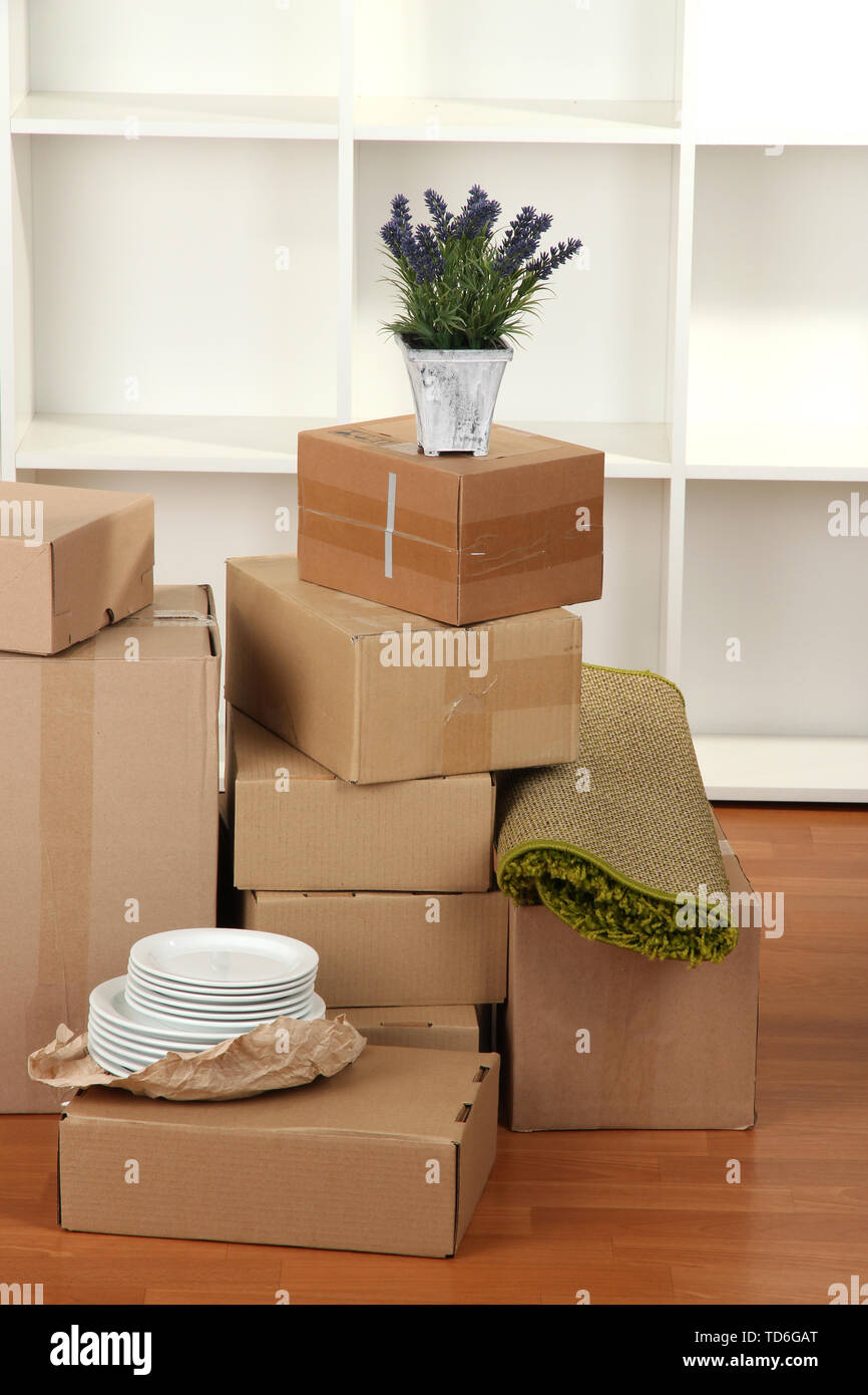 Moving boxes in empty room Stock Photo - Alamy