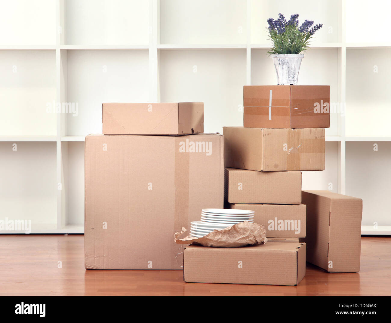 Moving boxes in empty room Stock Photo - Alamy
