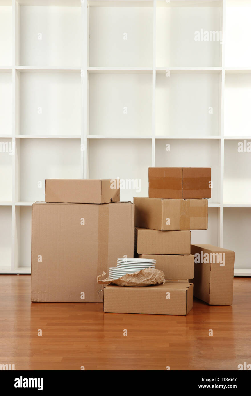 Moving boxes in empty room Stock Photo - Alamy