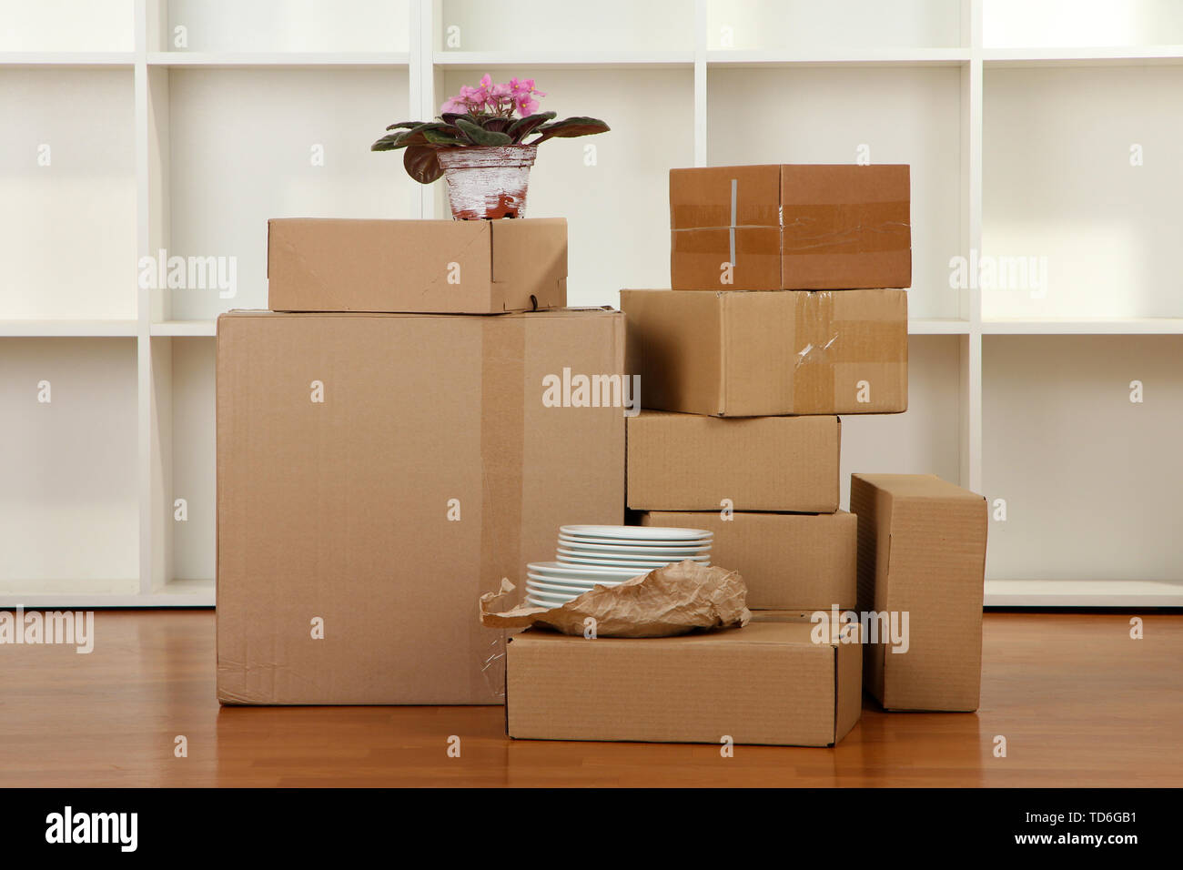 Moving boxes in empty room Stock Photo - Alamy