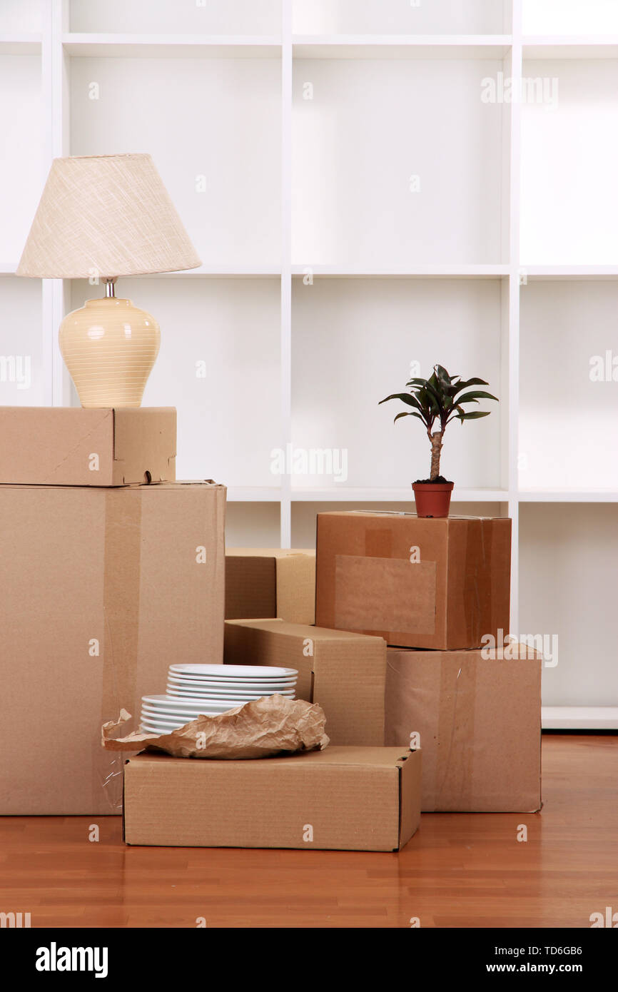 Moving boxes in empty room Stock Photo - Alamy