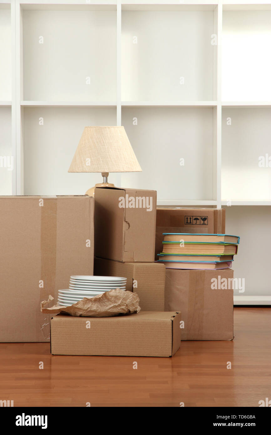 Moving boxes in empty room Stock Photo - Alamy