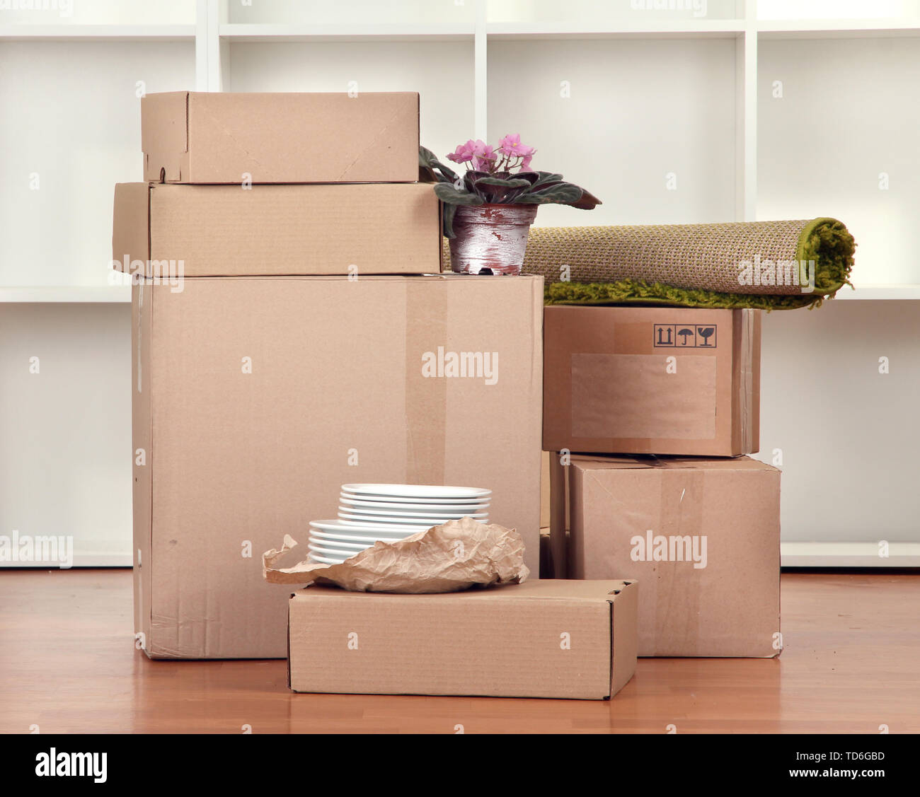 Moving boxes in empty room Stock Photo - Alamy