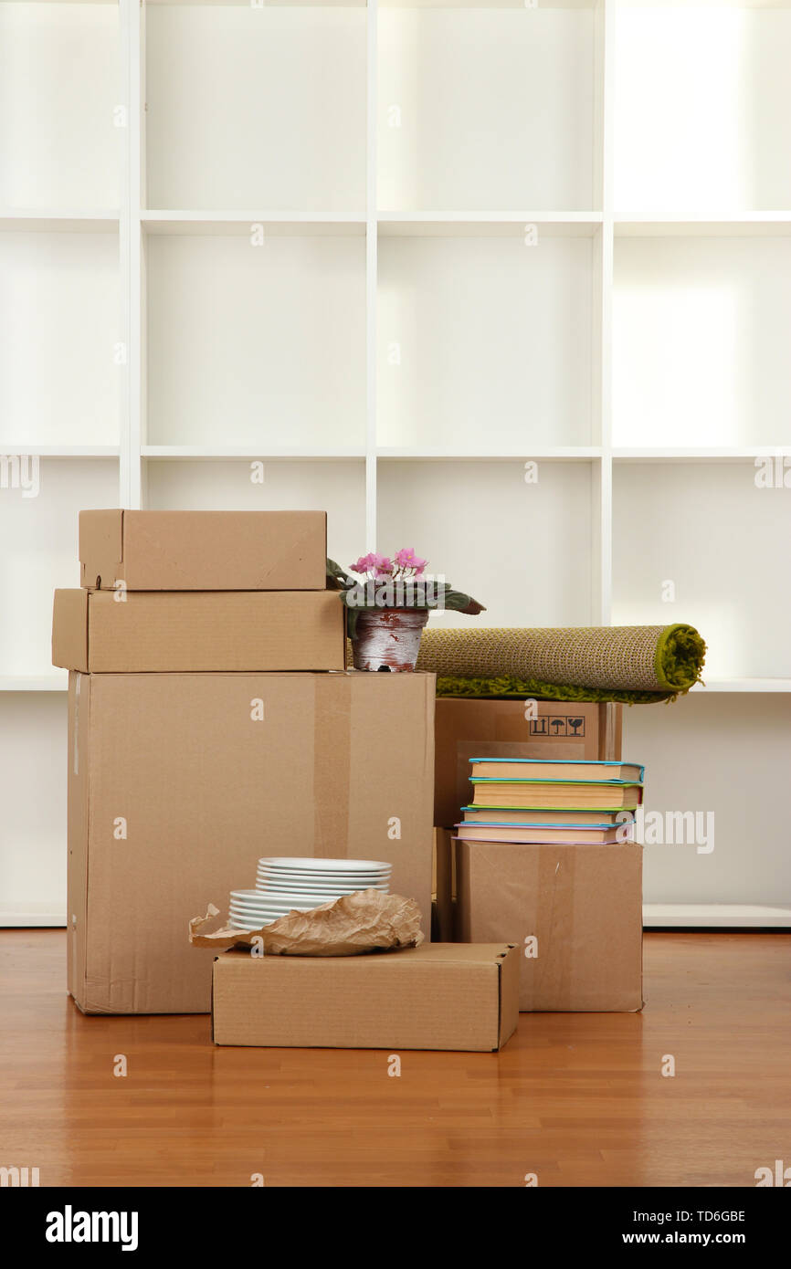 Moving boxes in empty room Stock Photo - Alamy