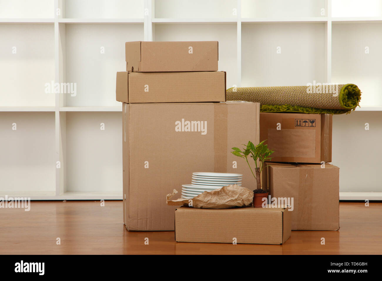 Moving boxes in empty room Stock Photo - Alamy
