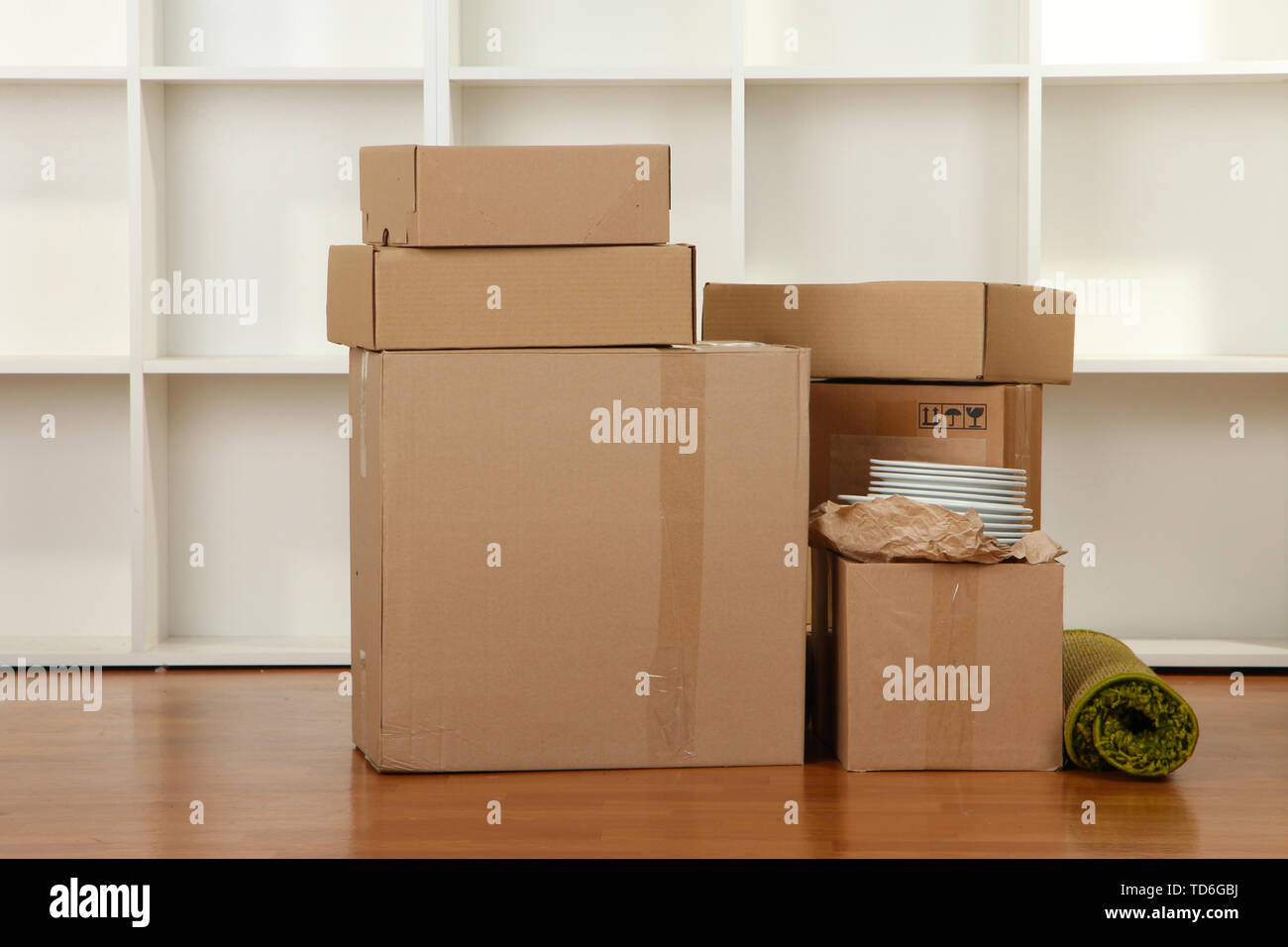 Moving boxes in empty room Stock Photo - Alamy