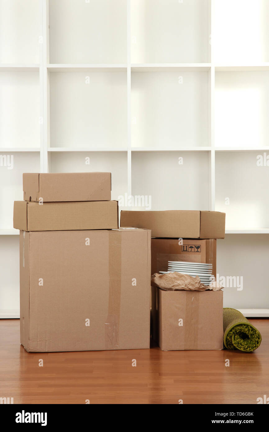 Moving boxes in empty room Stock Photo - Alamy