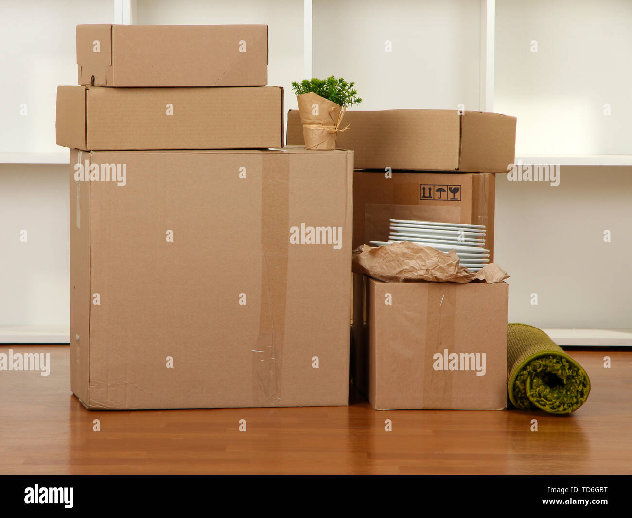 Moving boxes in empty room Stock Photo - Alamy