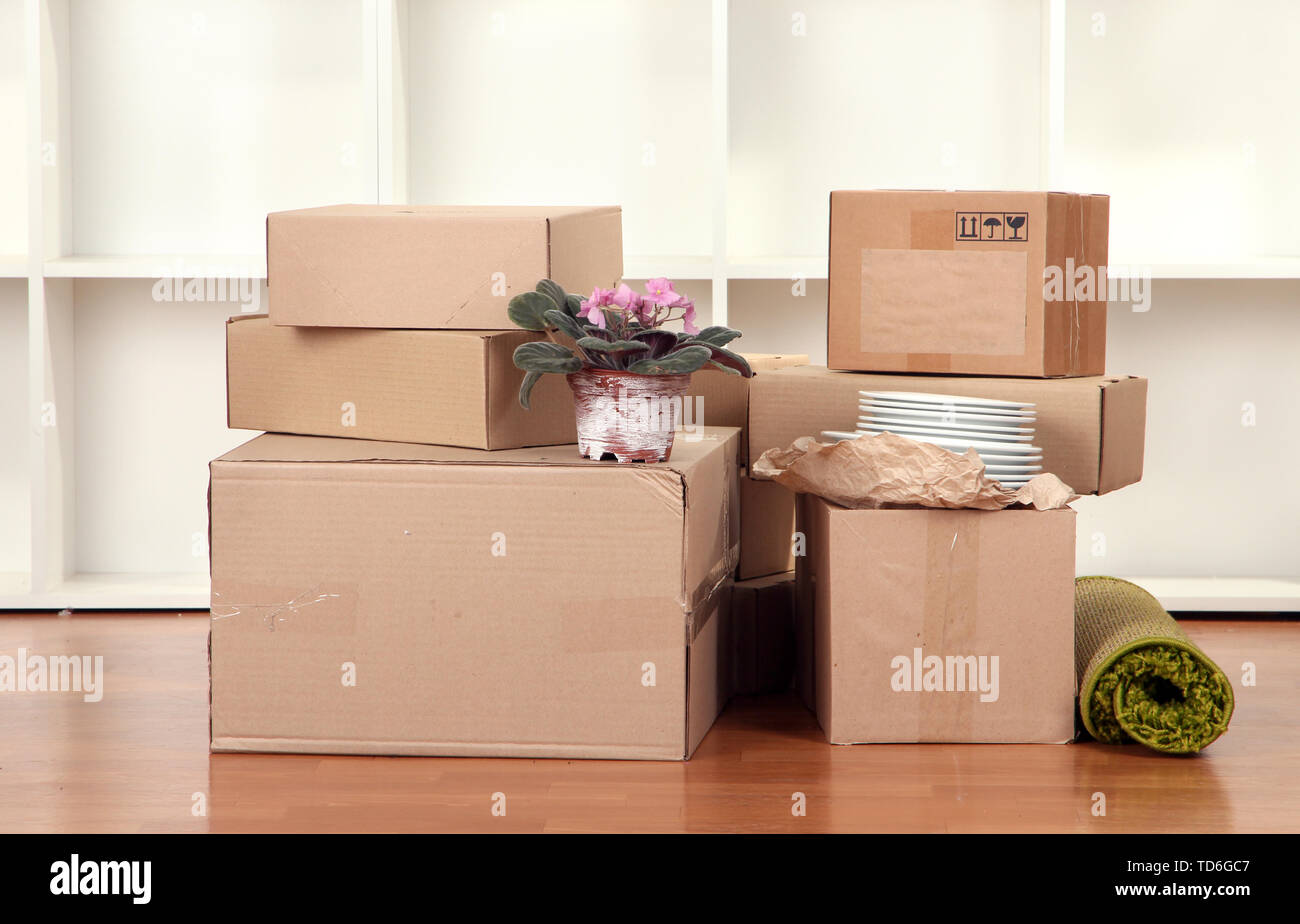 Moving boxes in empty room Stock Photo - Alamy