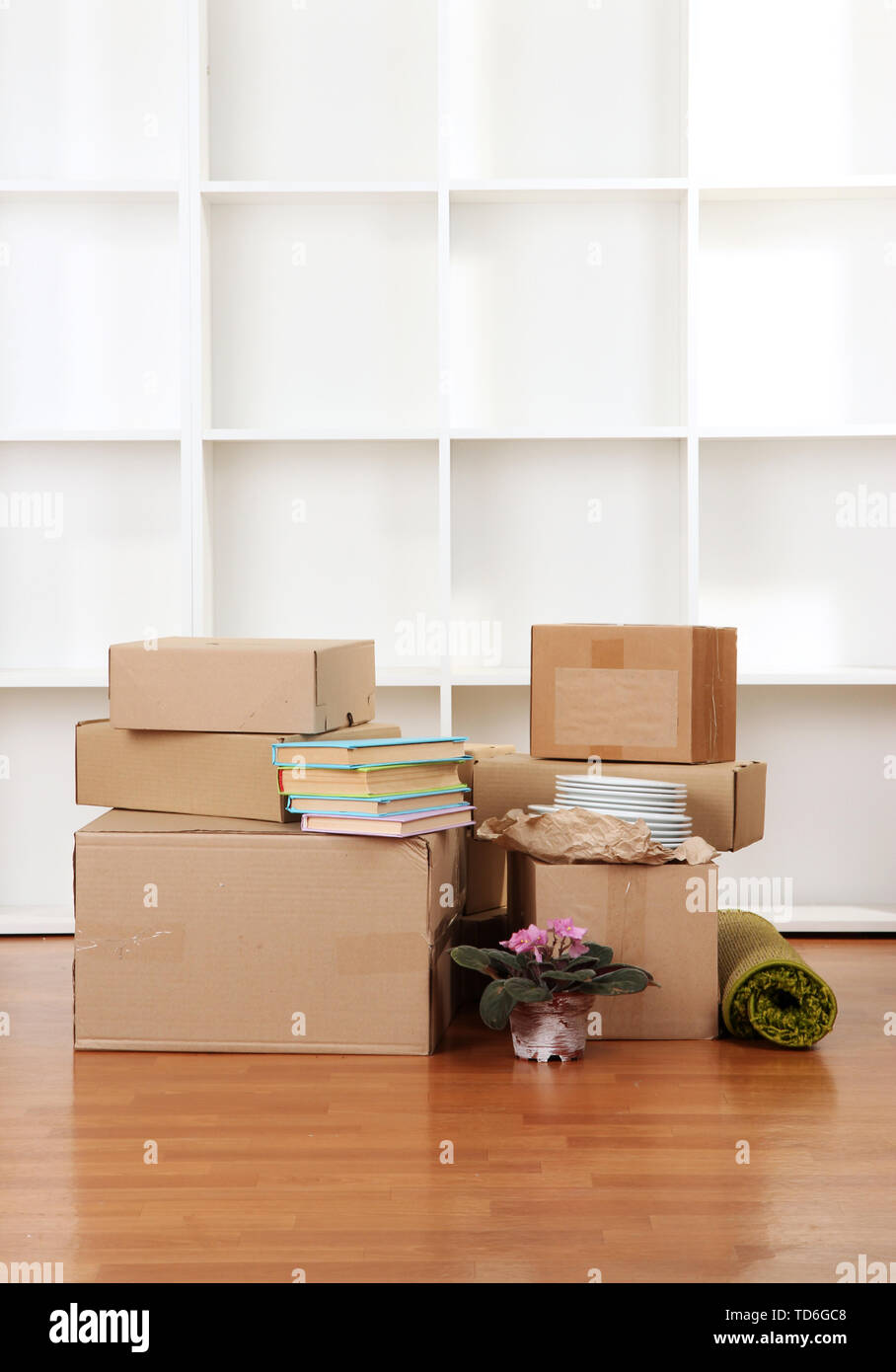 Moving boxes in empty room Stock Photo - Alamy