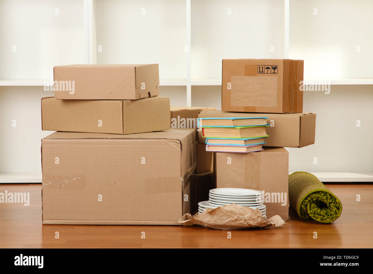 Moving boxes in empty room Stock Photo - Alamy