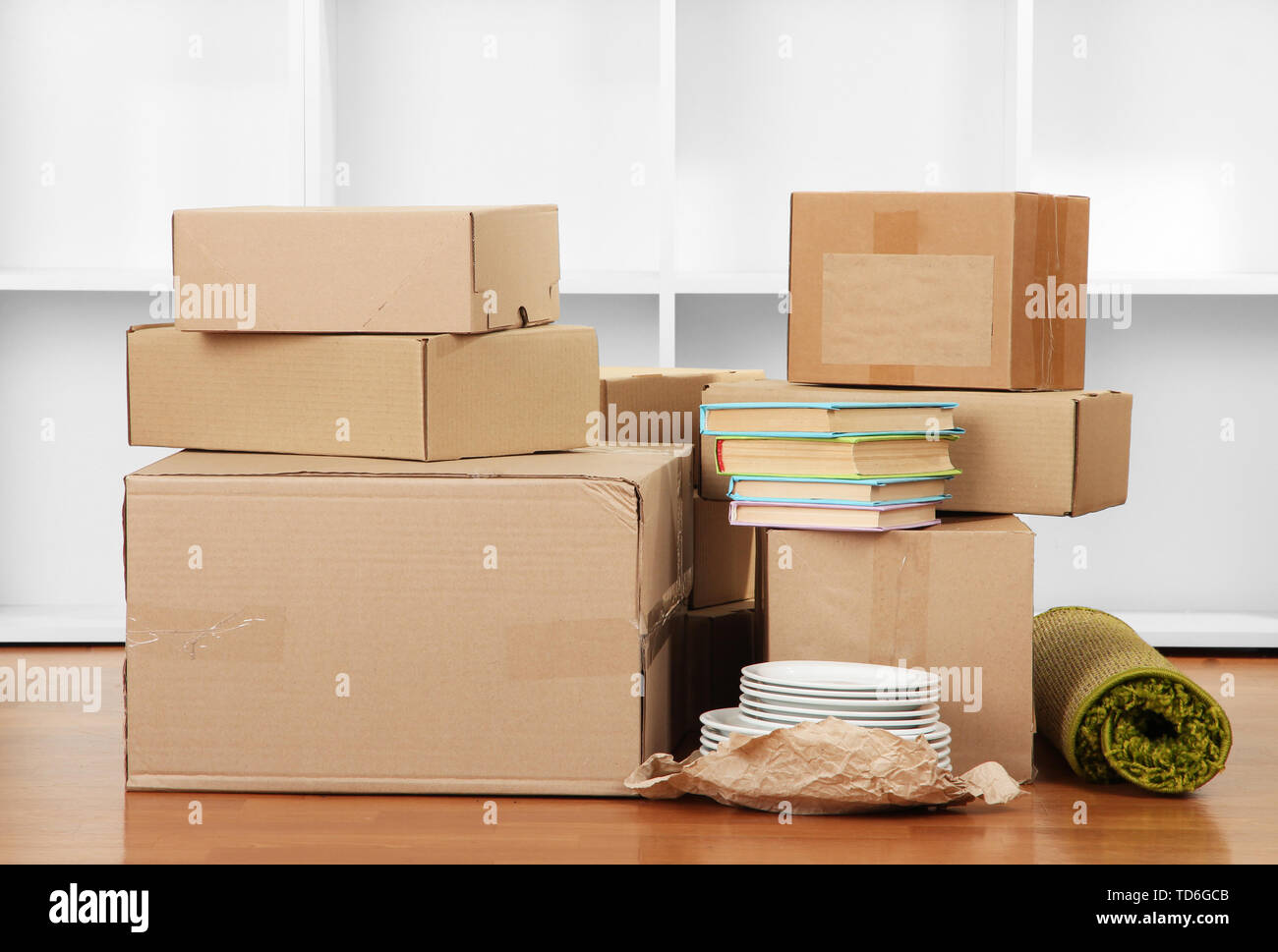 Moving boxes in empty room Stock Photo - Alamy