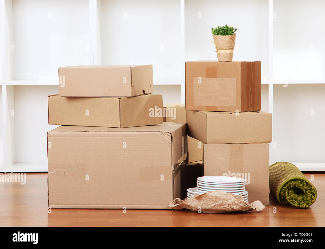 Moving boxes in empty room Stock Photo - Alamy