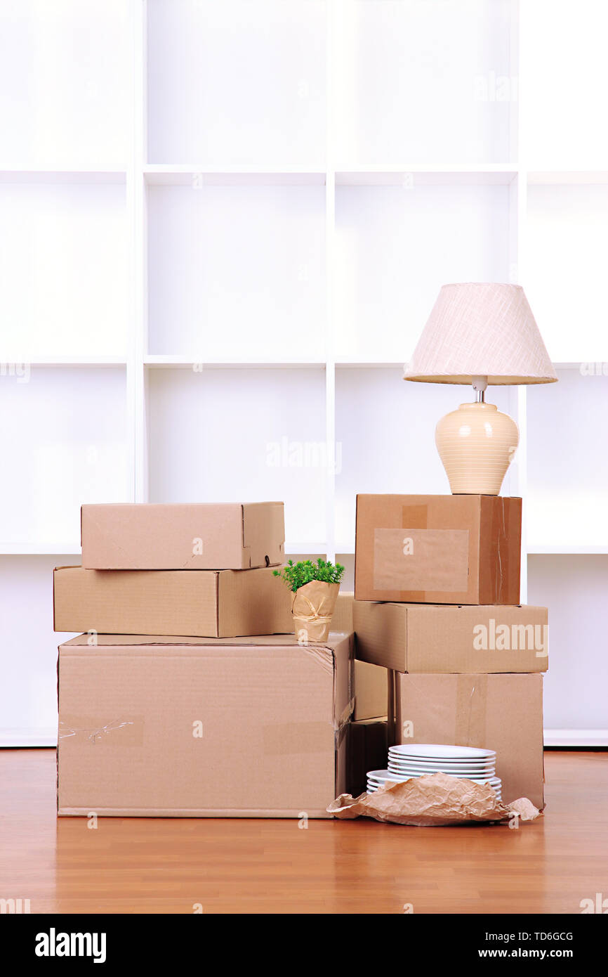 Moving boxes in empty room Stock Photo - Alamy