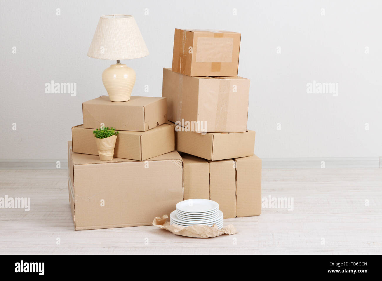 Moving boxes on the floor in empty room Stock Photo - Alamy
