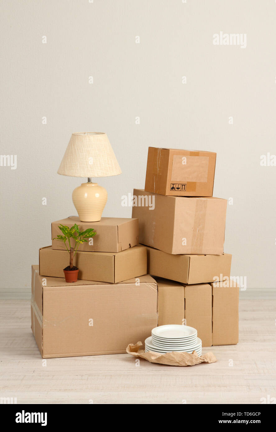 Moving boxes on the floor in empty room Stock Photo - Alamy