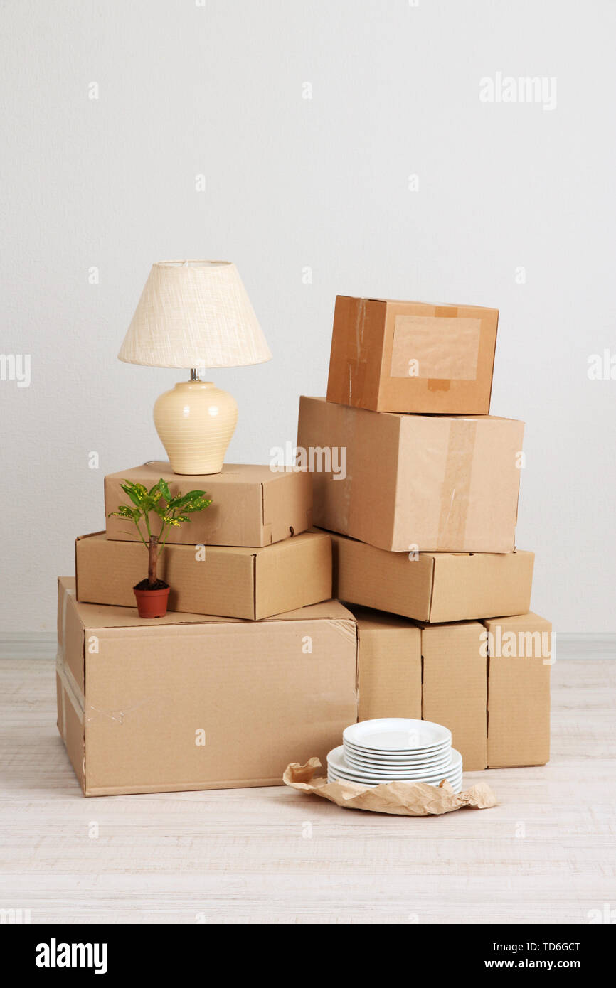 Moving boxes on the floor in empty room Stock Photo - Alamy