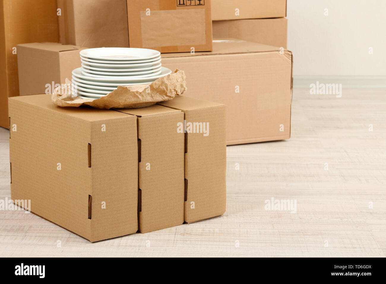Moving boxes on the floor in empty room Stock Photo - Alamy