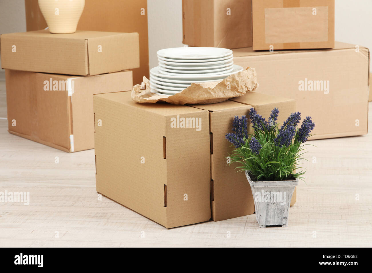Moving boxes on the floor in empty room Stock Photo - Alamy